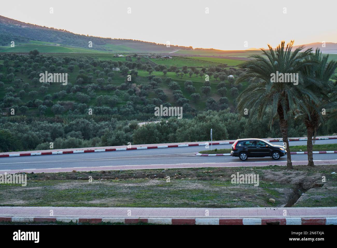 A car on asphalt road to an old Moroccan mountain town Stock Photo - Alamy