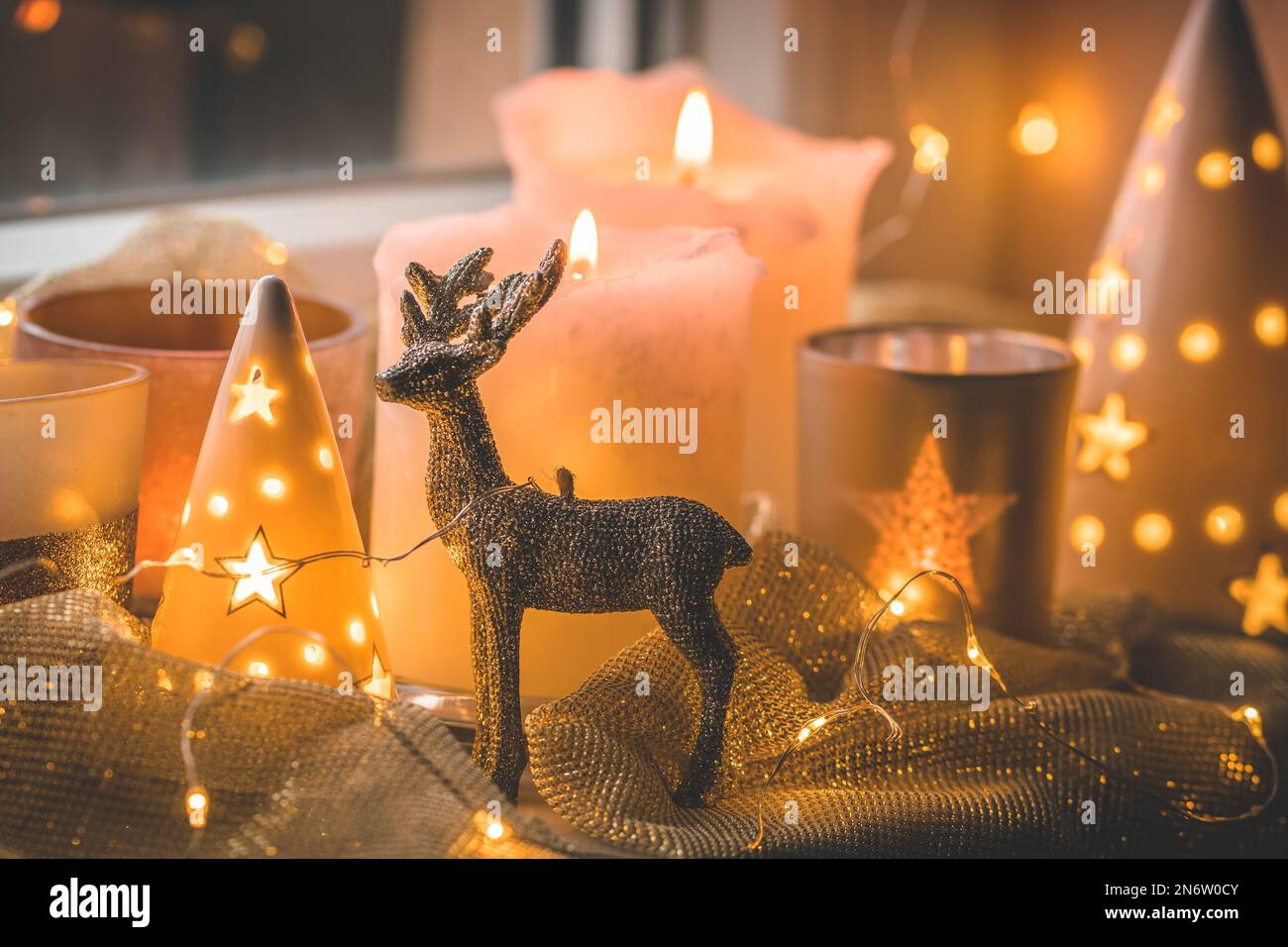 Christmas decorations in a window with glitter reindeer and various ...