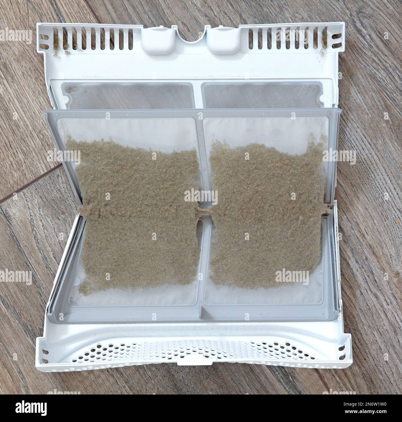 Dryer filter full of lint after clothes dried Stock Photo - Alamy