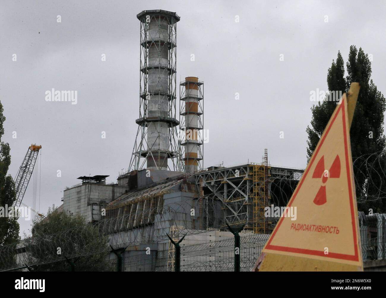 A chimney stands over the damaged reactor at the Chernobyl nuclear ...