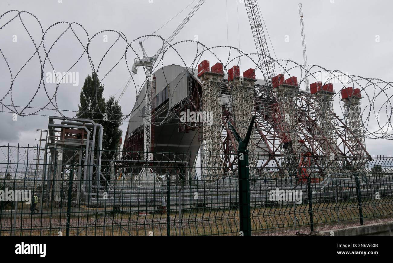 A gigantic steel arch under construction to cover the remnants of the ...