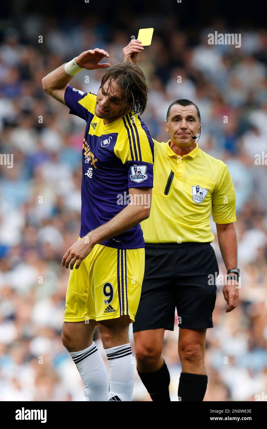 Swansea City's Miguel Michu reacts as referee shows him a yellow card ...