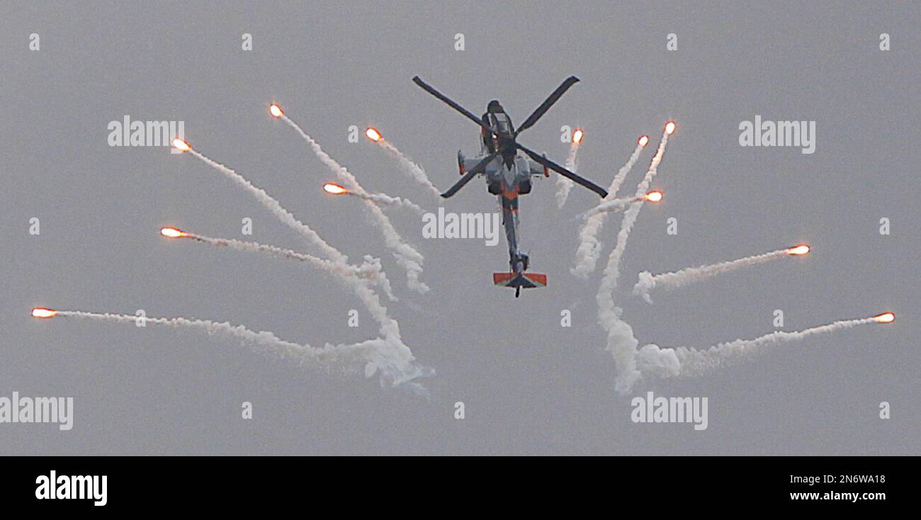 A Dutch AH-64 Apache helicopter fires flares during a performance at ...