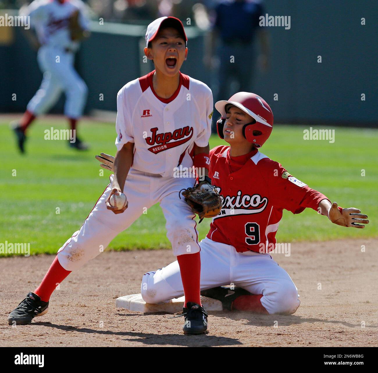 Tokyo, Japan, second baseman Dai Okada celebrates getting the force out ...