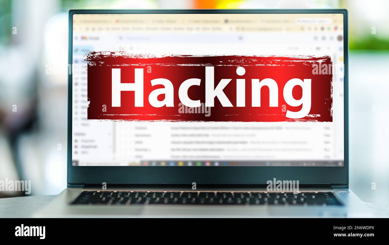 Laptop computer displaying the sign of hacking on an internet email ...