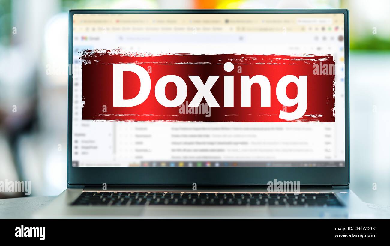 Laptop computer displaying the sign of doxing on an internet email site ...