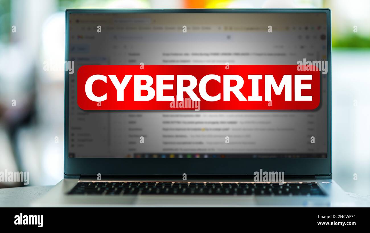Laptop computer displaying the sign of cybercrime on an internet email ...