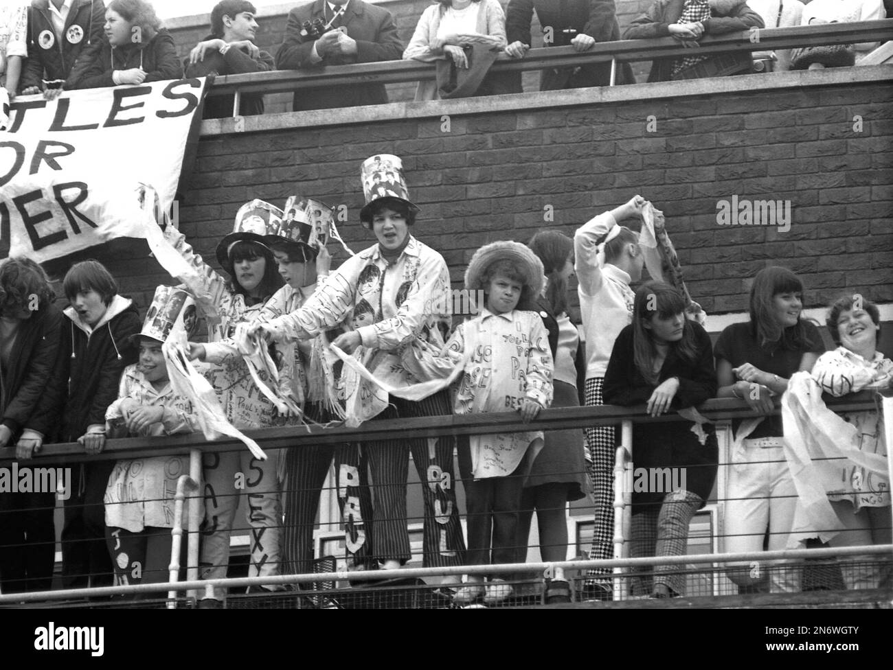 Teenage Beatles fans, wearing tee shirts covered in Beatles related ...