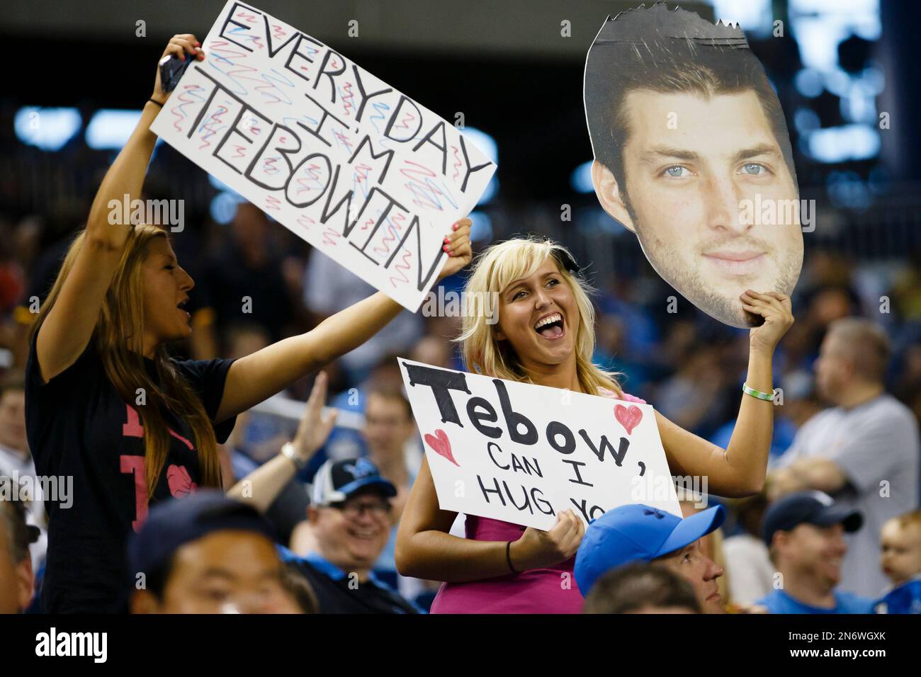 Fan hold up signs for New England Patriots quarterback Tim Tebow before ...