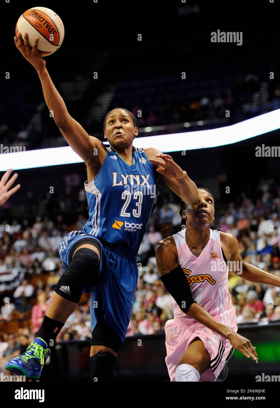Minnesota Lynx's Maya Moore, left, goes up for a shot while guarded by ...