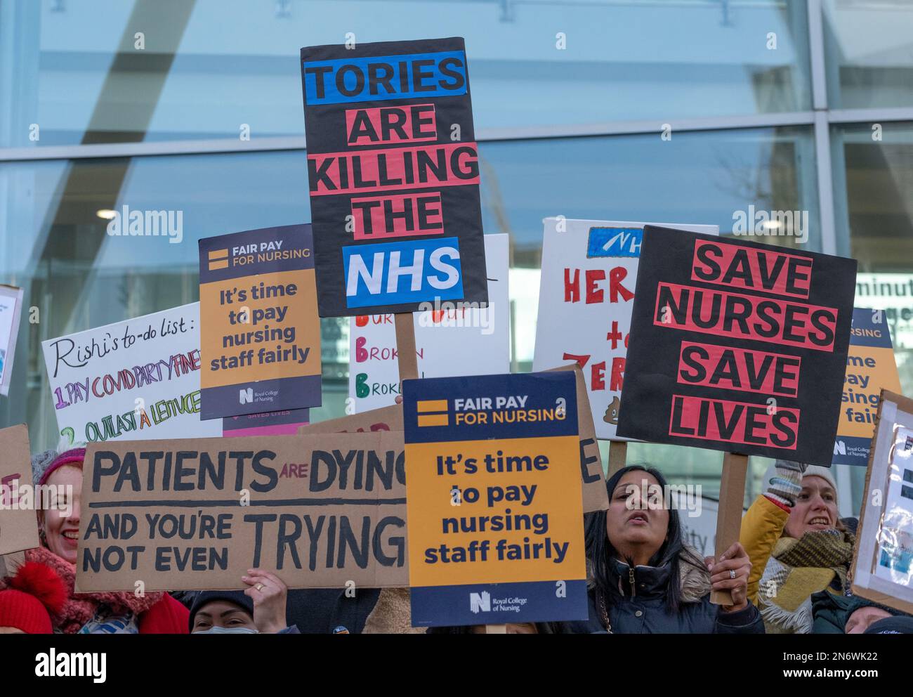 Striking nurses with placards, demonstrating outside University College ...