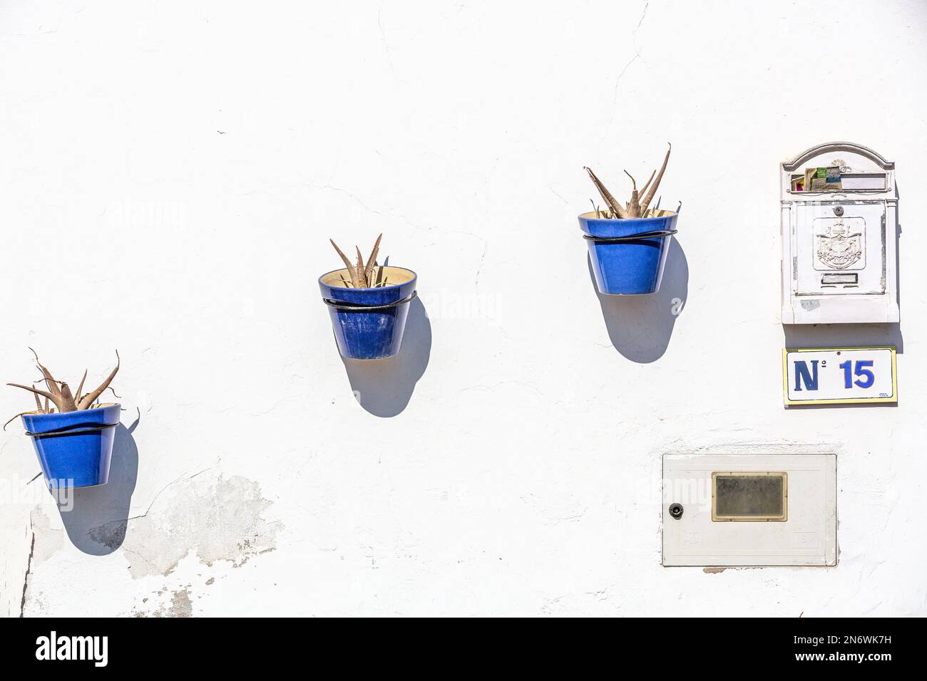 Three blue flower pot on a white wall. Letter box. Ajuy, Fuerteventura ...