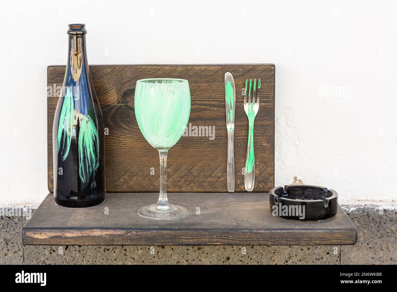 Cutlery arrange, stained with green, as outdoor decoration of a tapas ...