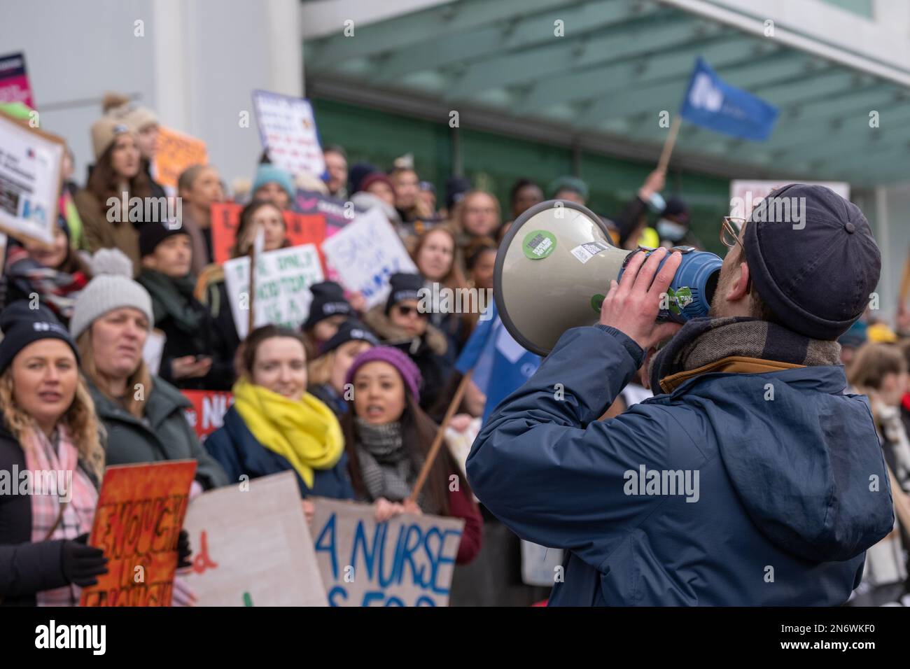 Striking nurses with placards, demonstrating outside University College ...