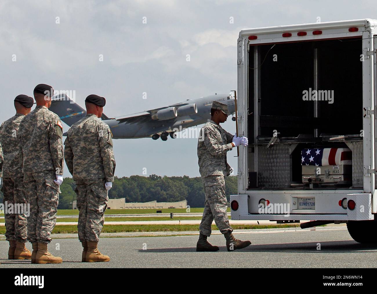Airman Simeon Boyd closes the door of the transfer vehicle containing ...