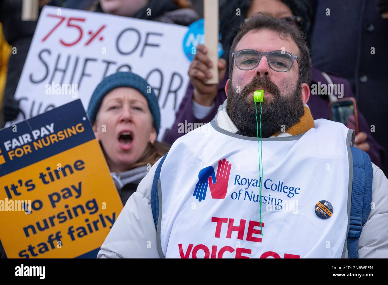 Striking nurses with placards, demonstrating outside University College ...
