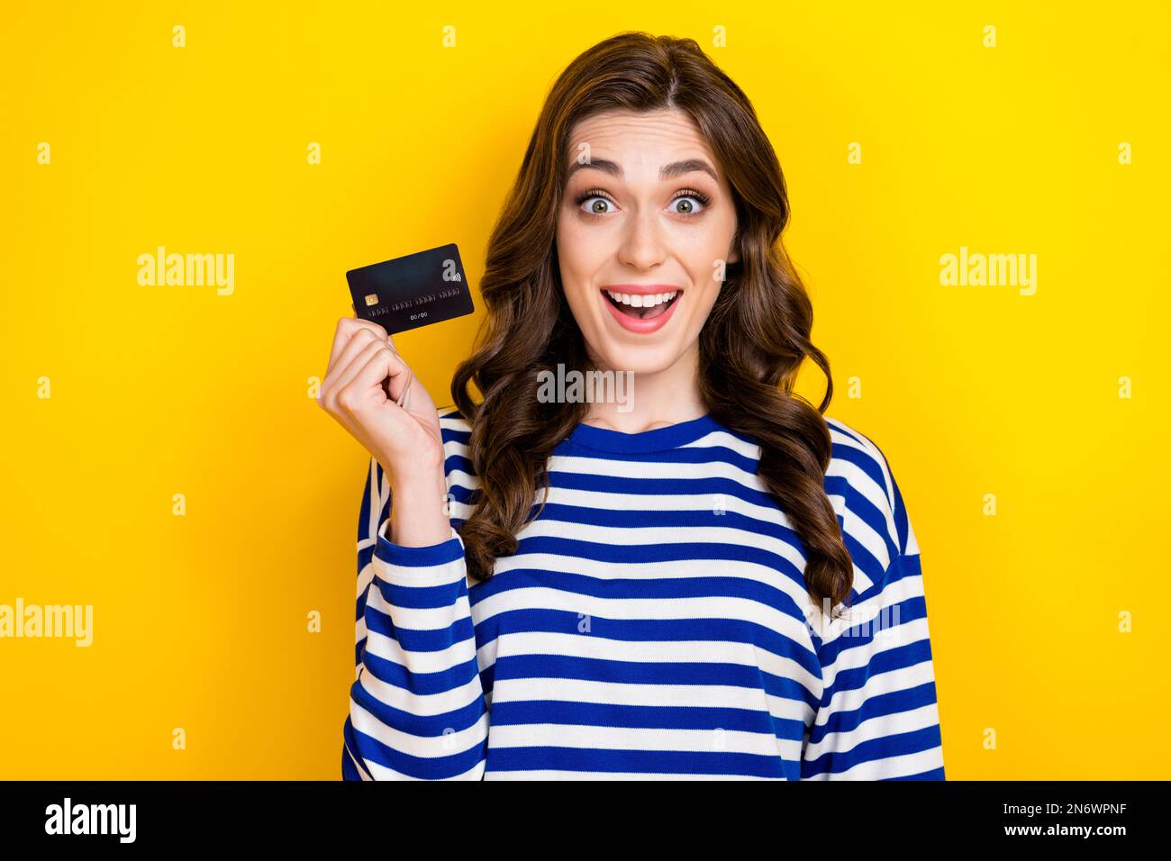 Photo of astonished cheerful lady hand hold showing debit card isolated ...