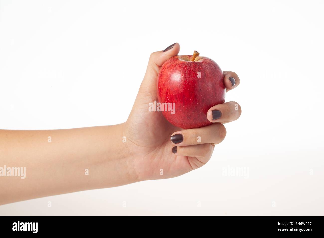 Hand holding whole red apple isolated on white background Stock Photo ...