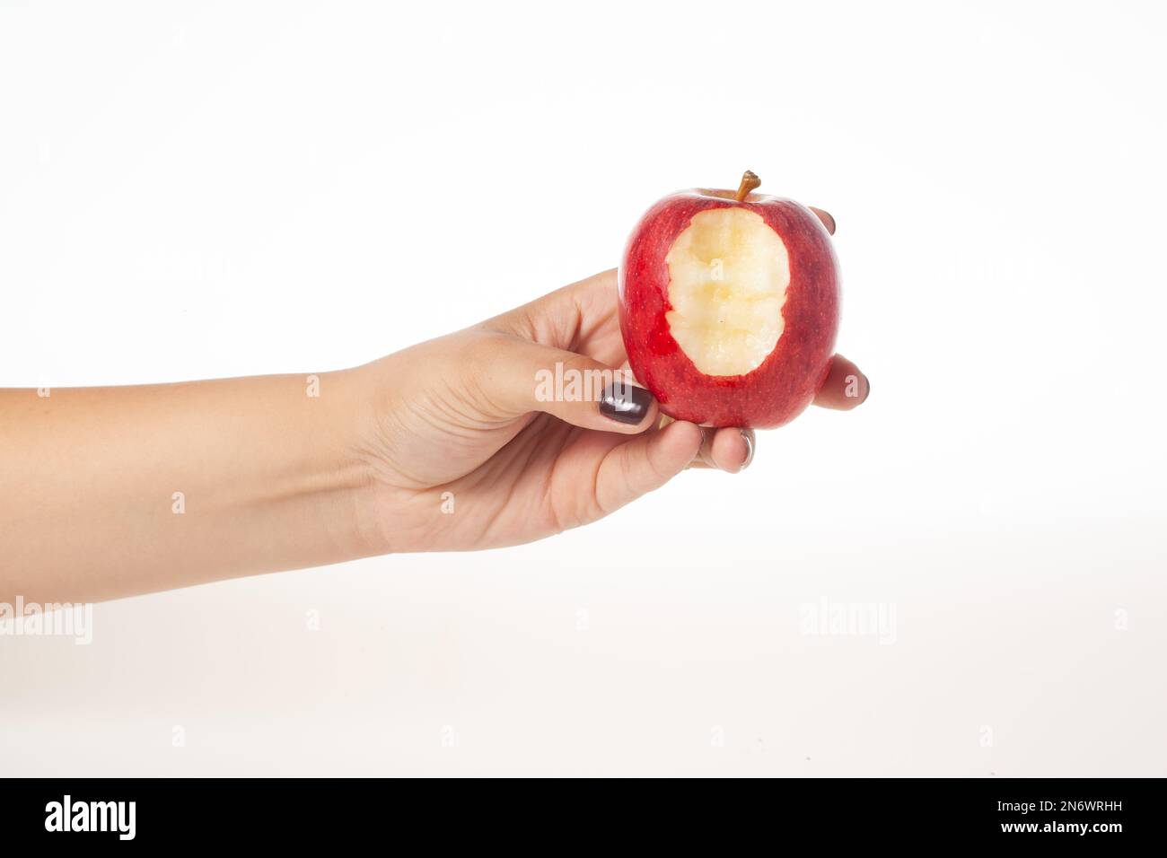 Hand holding bitten red apple isolated on white background Stock Photo ...