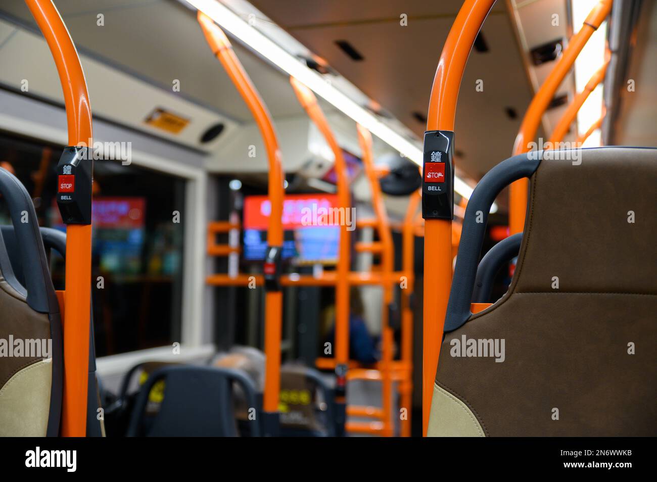 A red stop button on an orange pole in a public bus Stock Photo - Alamy