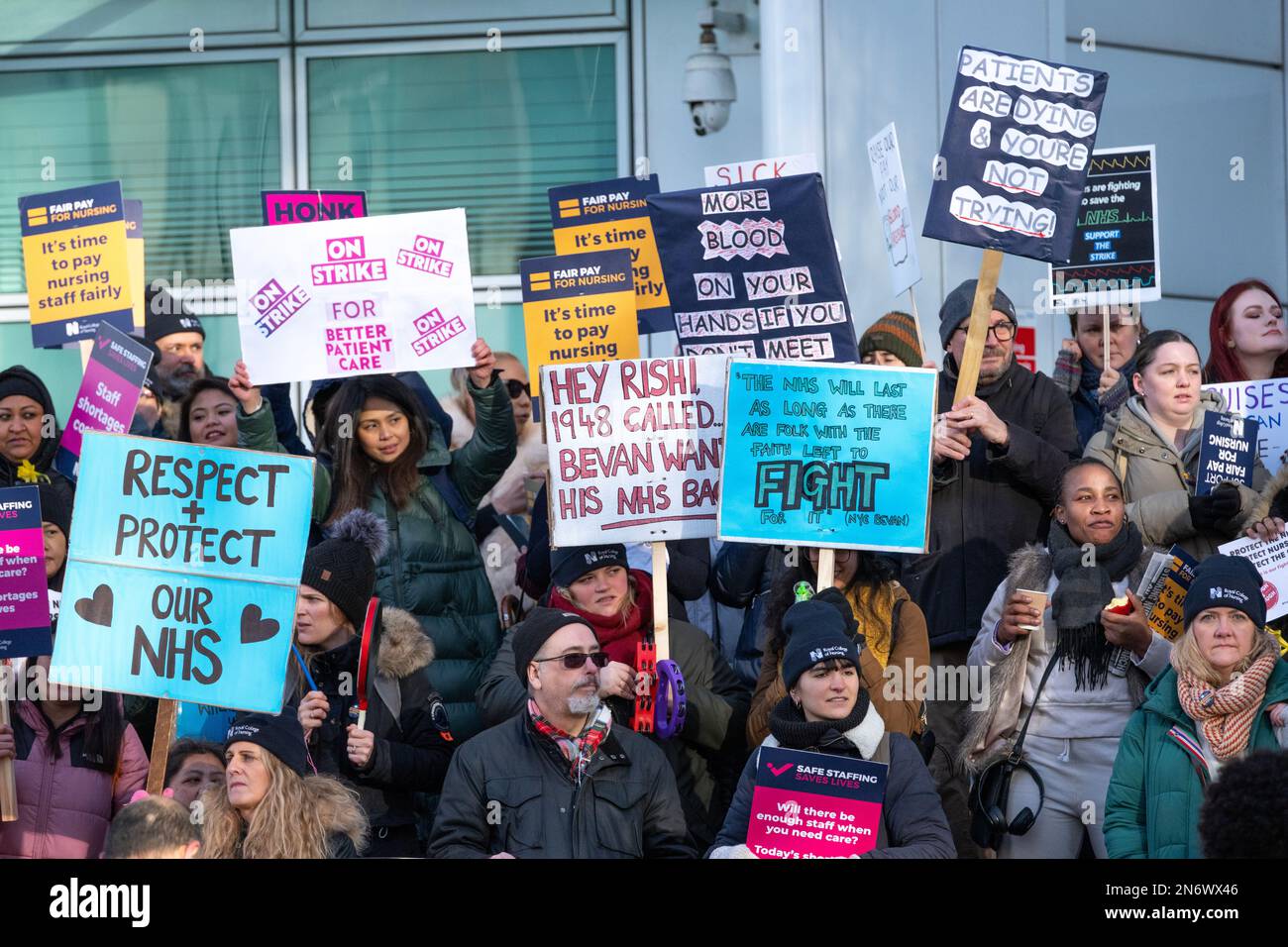 Striking nurses with placards, demonstrating outside University College ...