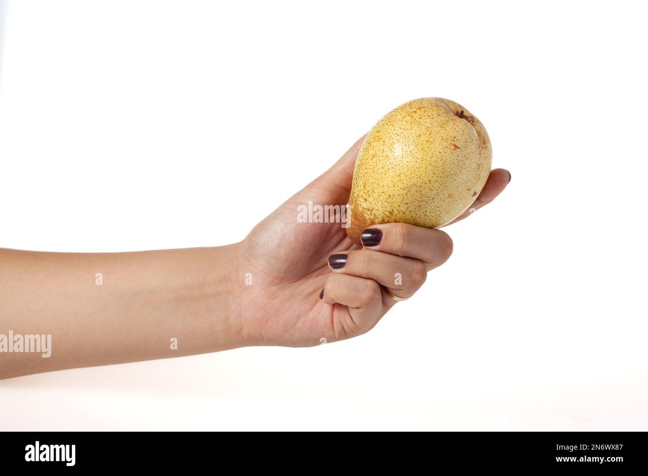 Hand holding whole pear isolated on white background Stock Photo - Alamy
