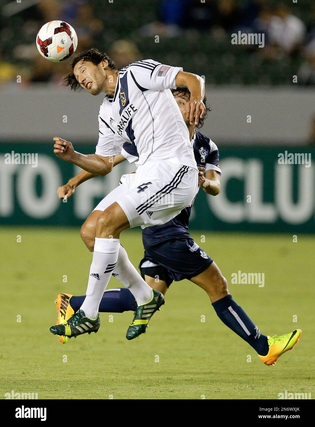 Los Angeles Galaxy's Omar Gonzalez, left, heads the ball away from ...