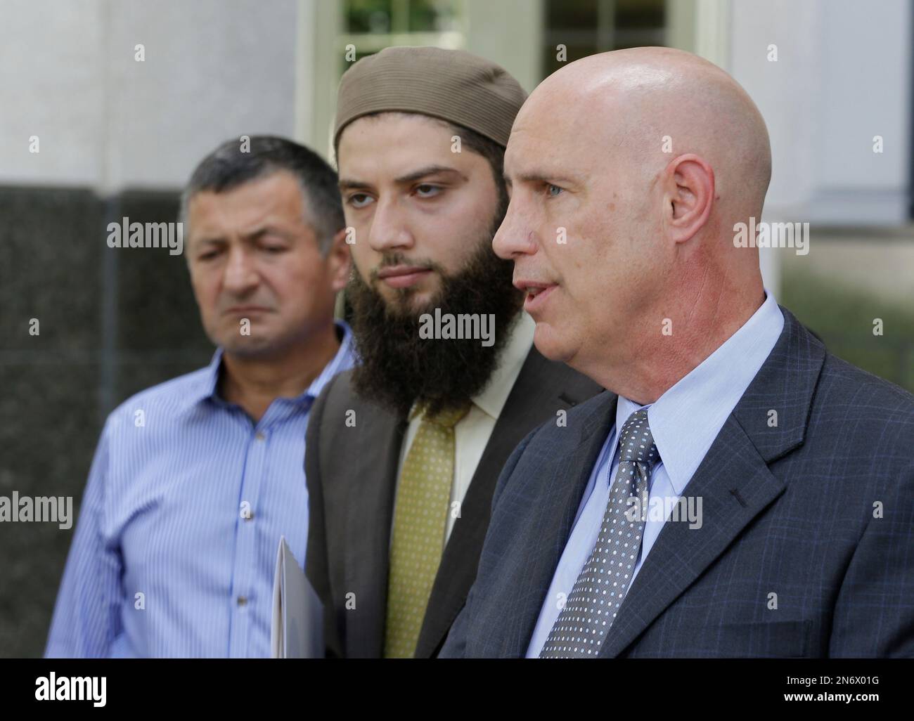 Attorney Eric Ludin, right, speaks with members of the media with ...