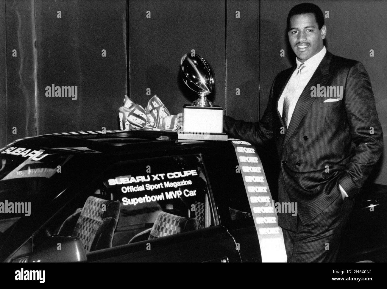 Richard Dent of the Chicago Bears poses with the trophy awarded to him ...