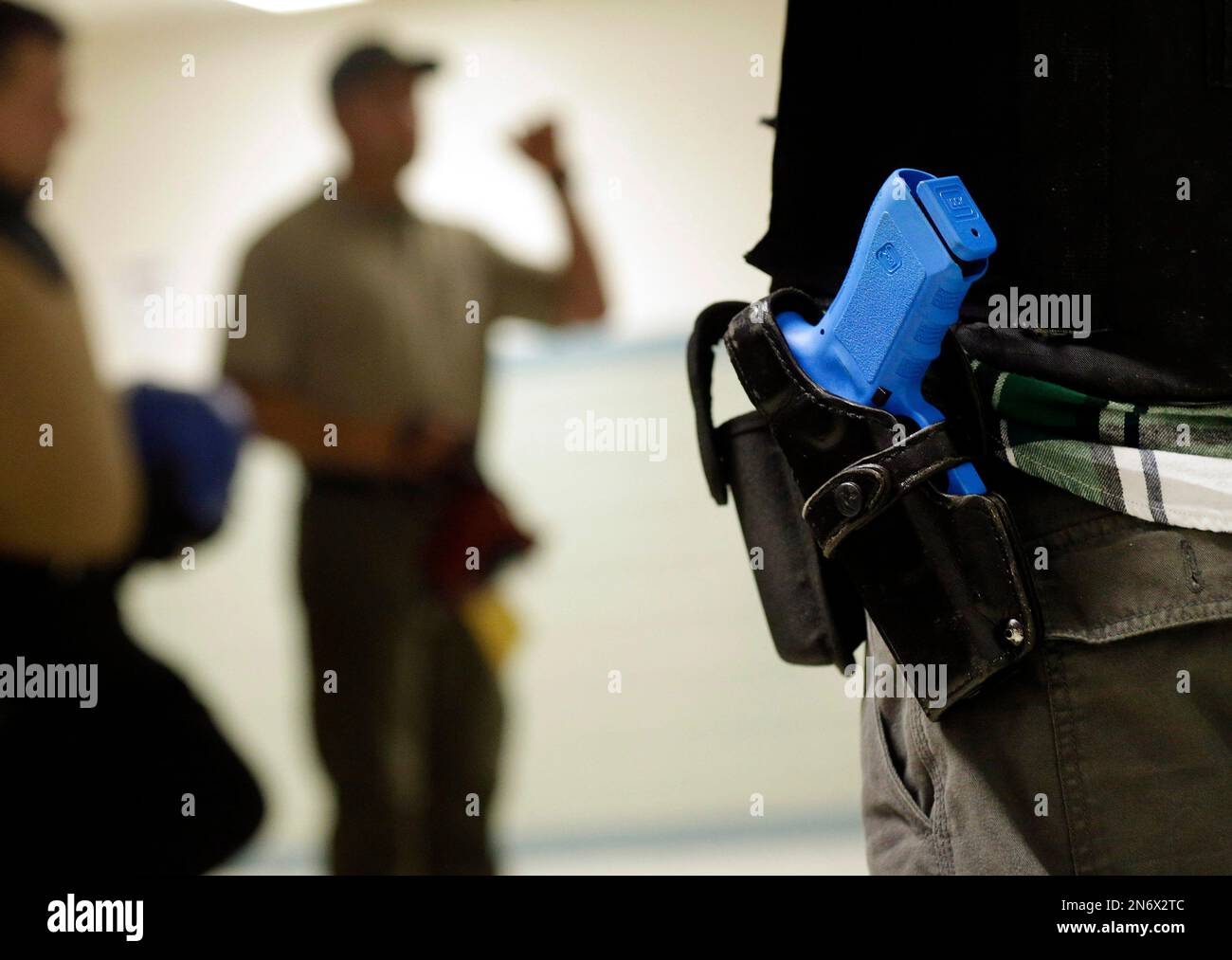 In this Tuesday, Aug. 13, 2013 photo, a police officer carries a ...