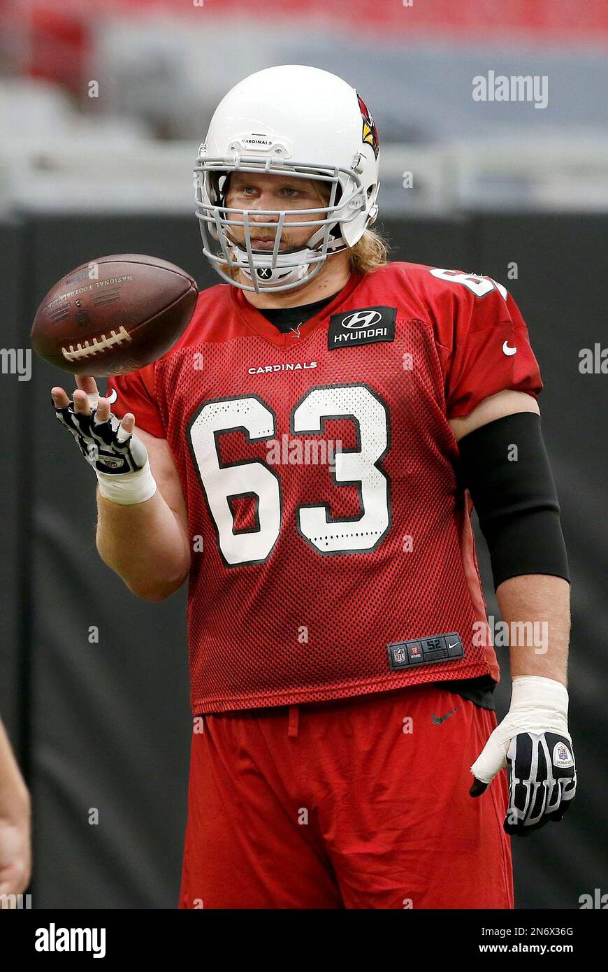 Arizona Cardinals' Lyle Sendlein flips the football during NFL football ...