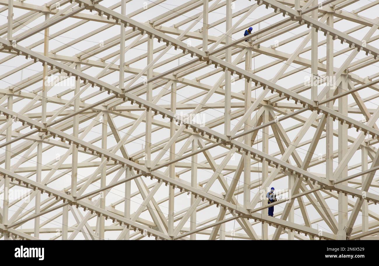 Men work amid the web rafters at Arena Corinthians in Sao Paulo, Brazil ...