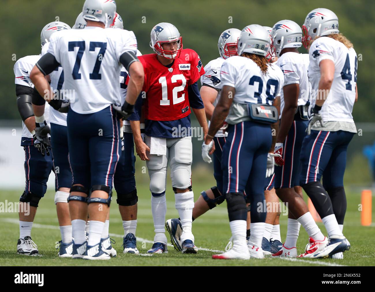 New England Patriots quarterback Tom Brady (12) huddles with the ...