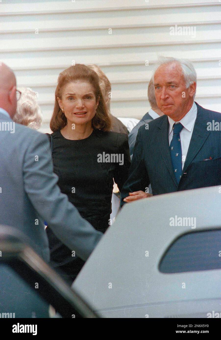 Jacqueline Kennedy Onassis is escorted by an unidentified family friend ...
