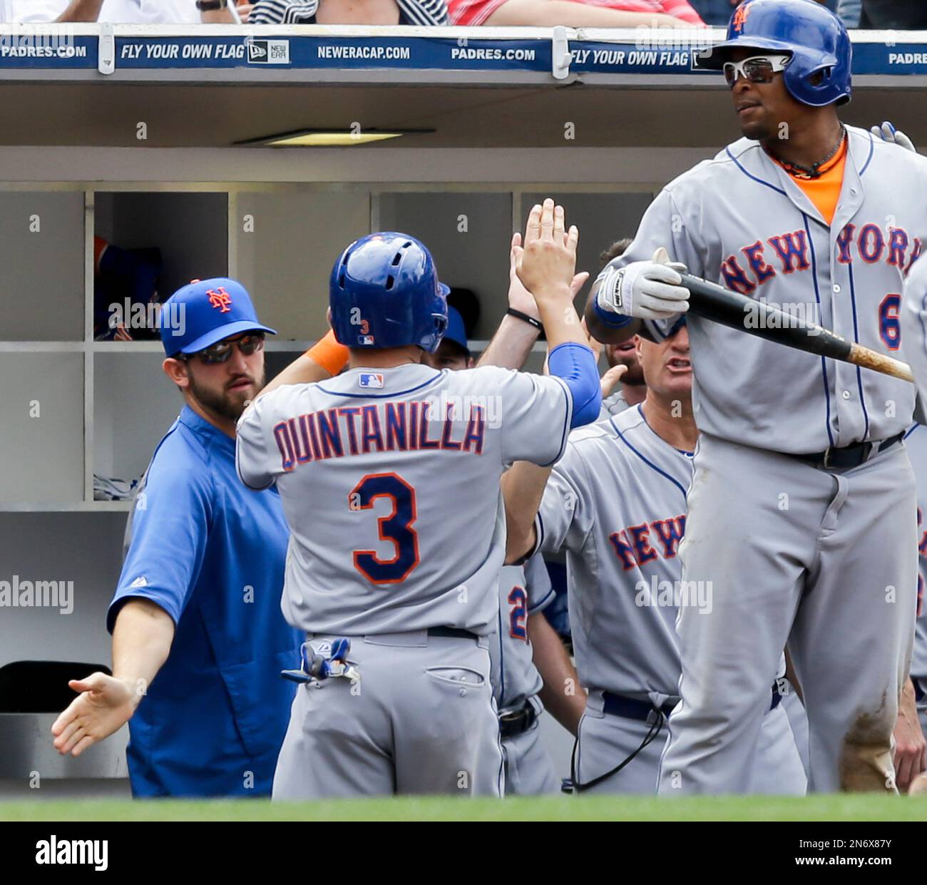 New York Mets' Omar Quintanilla (3) is greeted at the dugout after ...