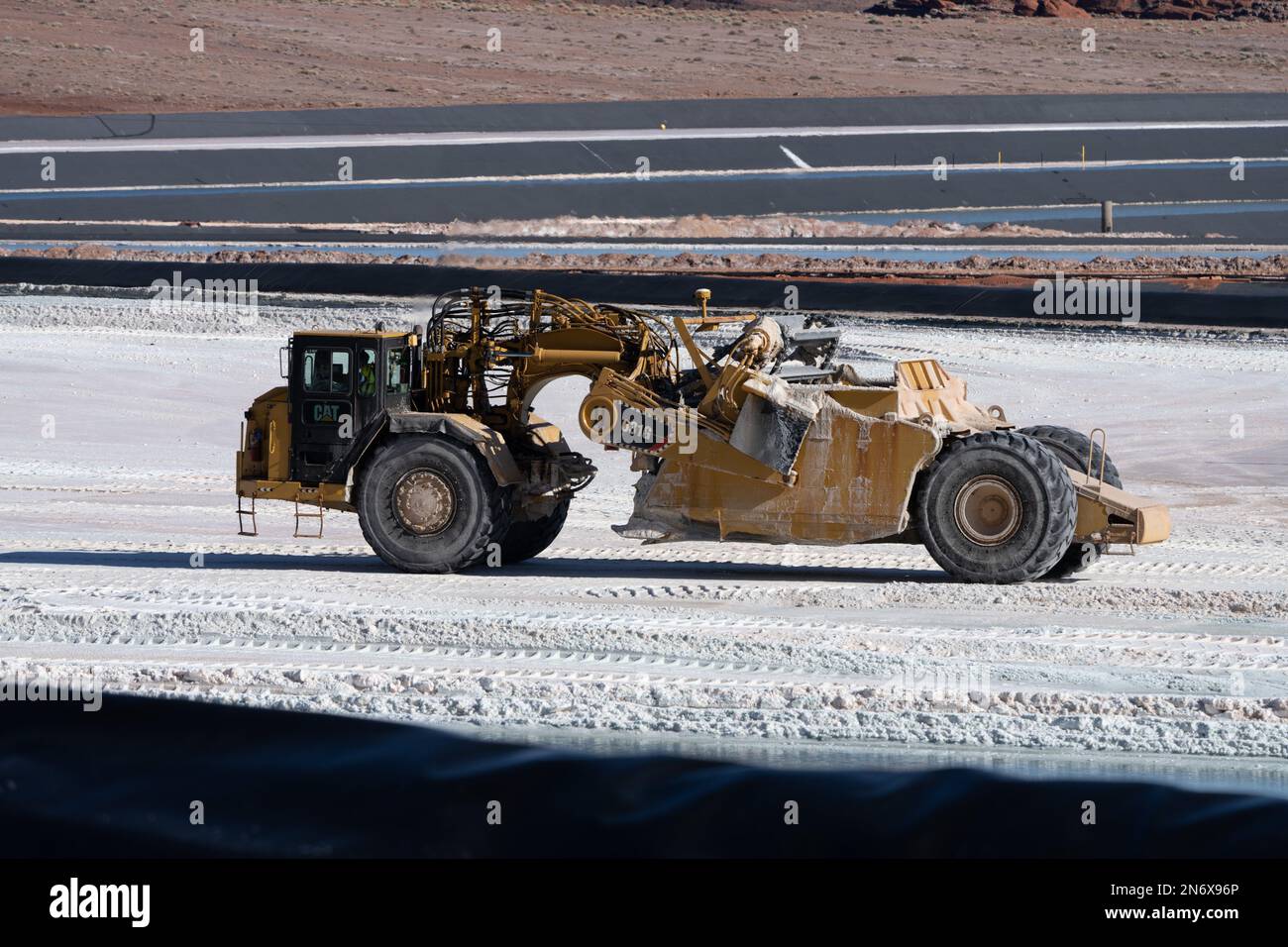 A heavy-duty scraper harvesting potash from an evaporation pond at a ...