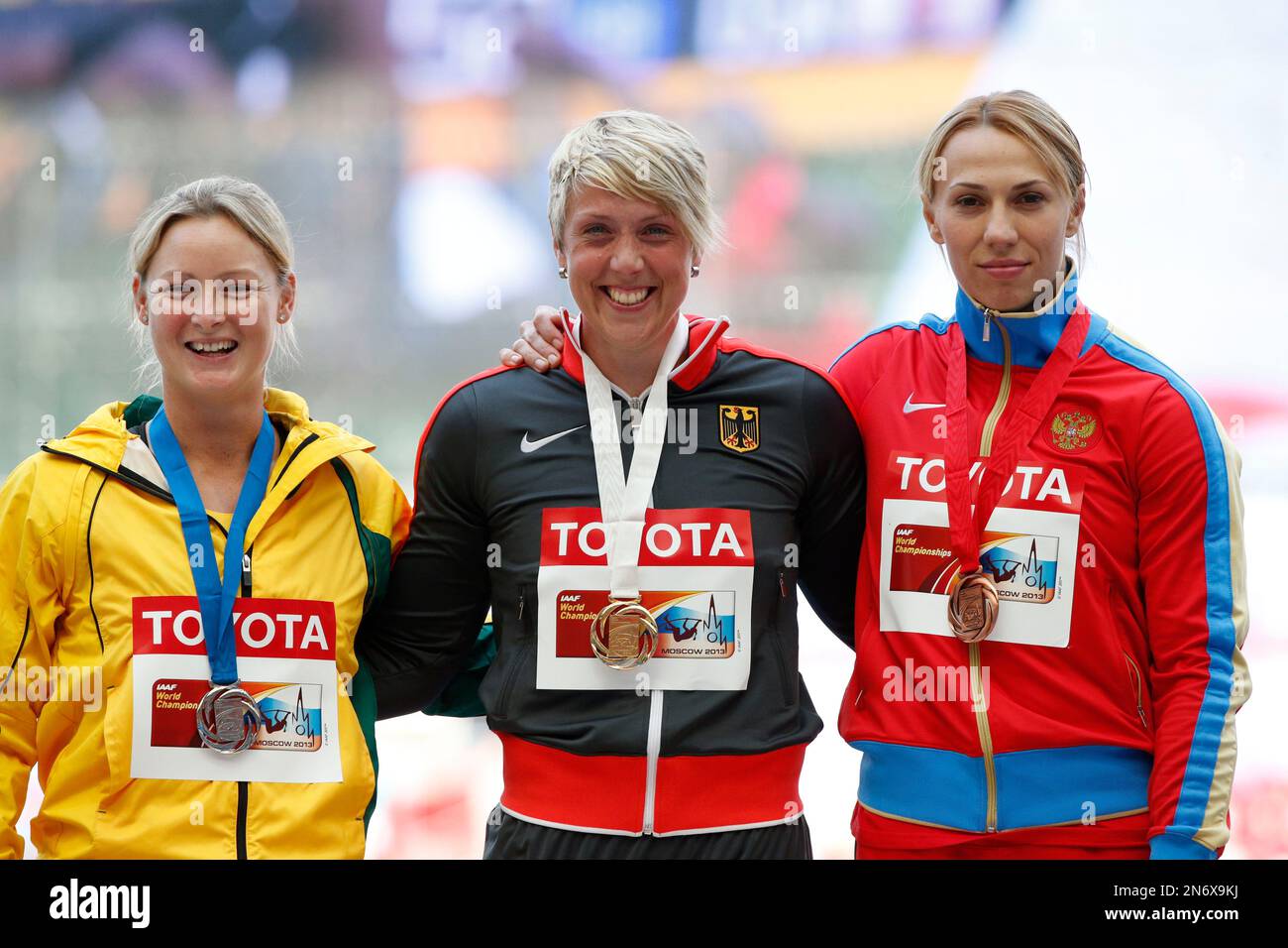 Germany's gold medal winner Christina Obergfoll is flanked by silver ...