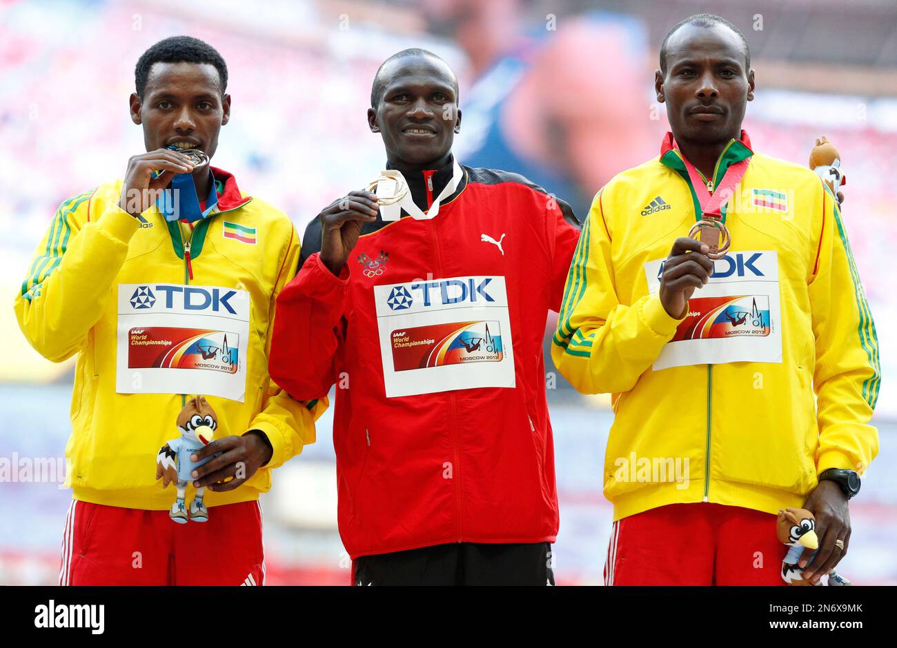Uganda's gold medalist Stephen Kiprotich is flanked by silver medal winner Lelisa Desisa of ...