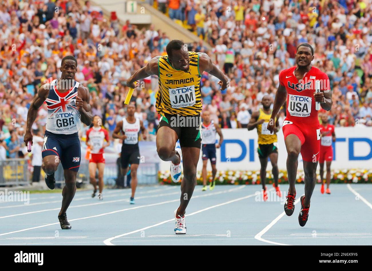 Jamaica's Usain Bolt, center, crosses the finish line ahead of United ...