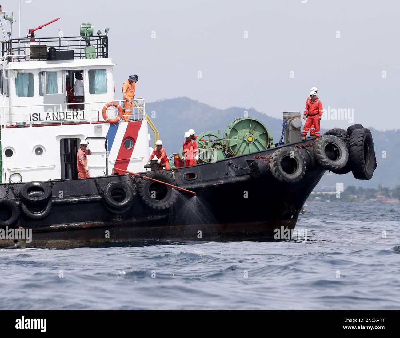 A private vessel sprays chemical dispersant to prevent the oil slick ...