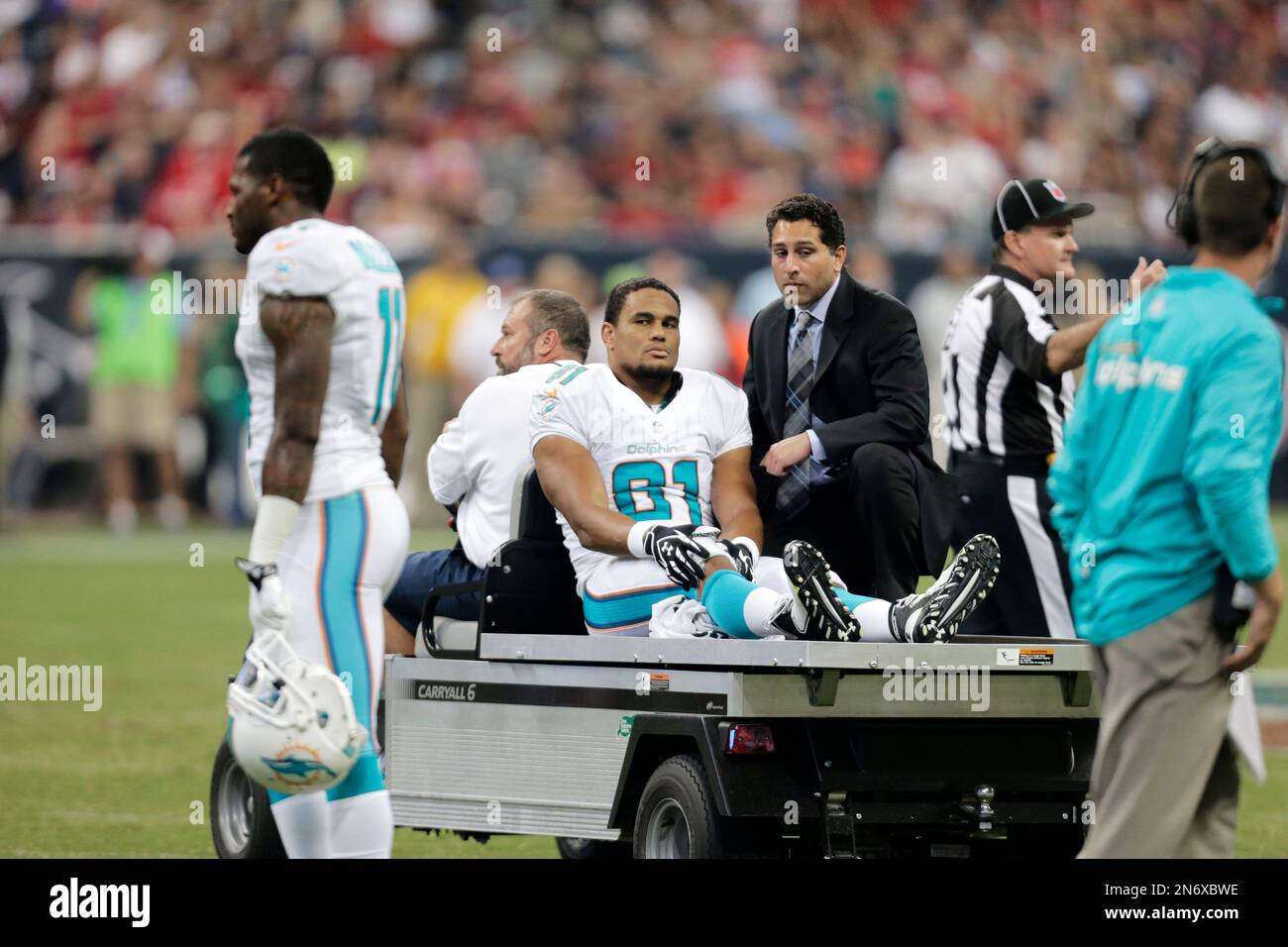 Miami Dolphins tight end Dustin Keller (81) is taken off the field ...
