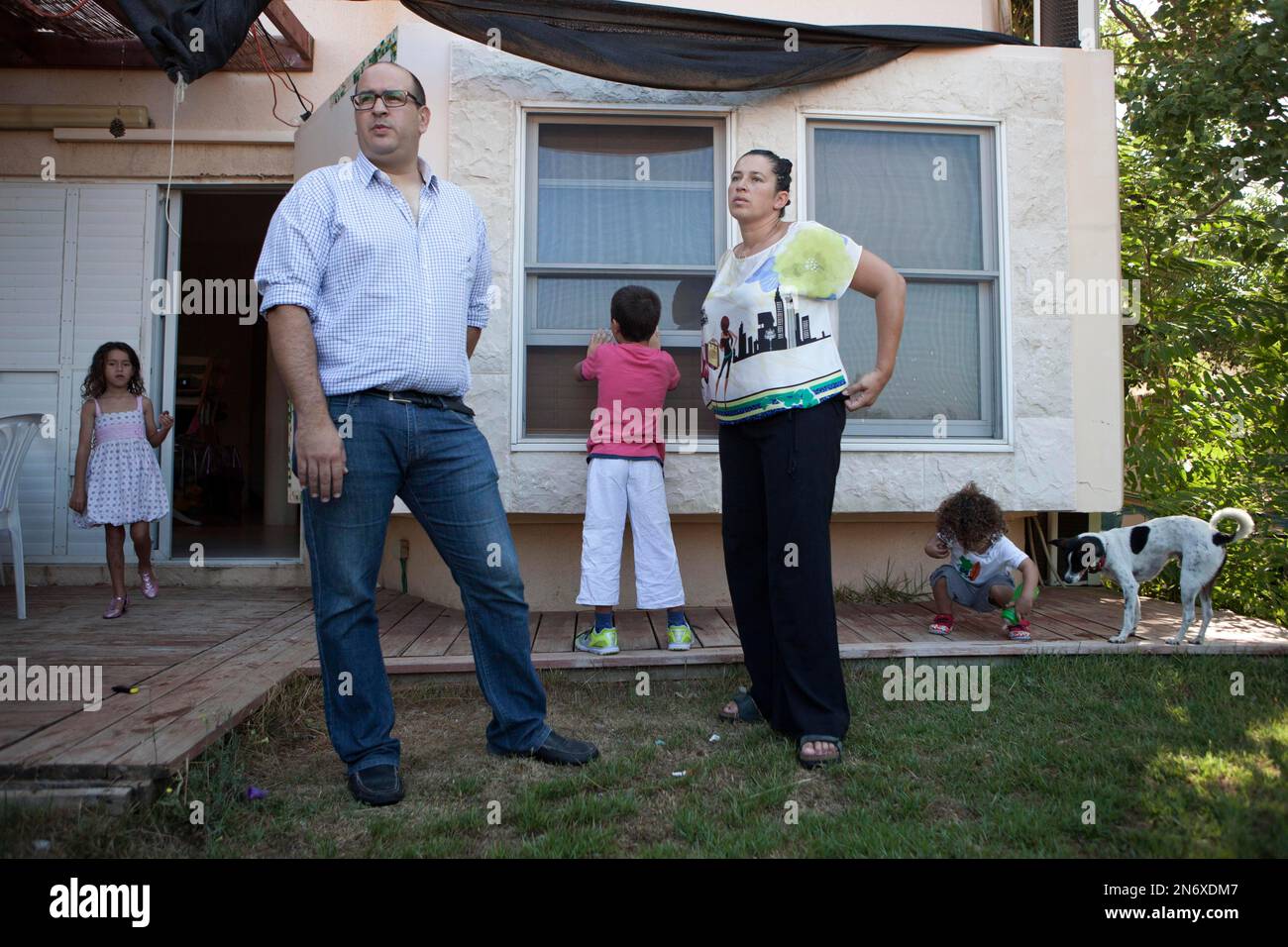 In this Sunday, Aug. 11, 2013, photo, Micha Drori, his wife, Ora, and ...