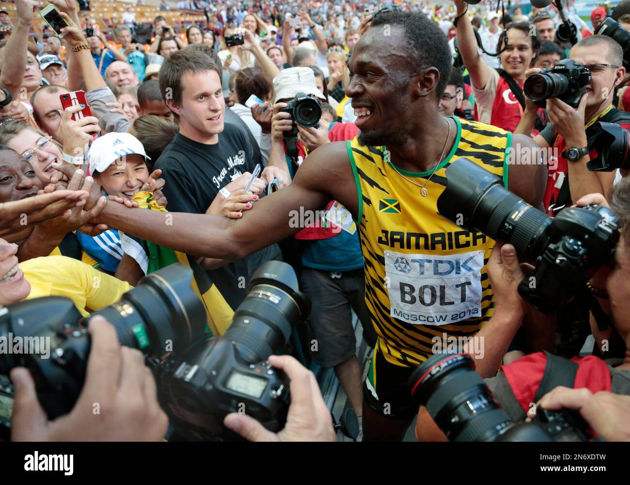Jamaica's Usain Bolt is surrounded spectators and photographers as he ...