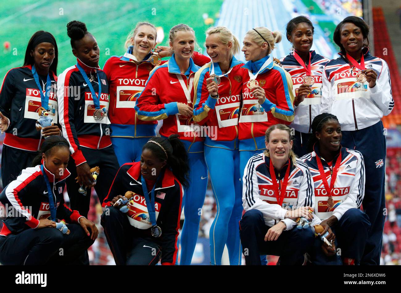 The Russian relay team, center, the U.S. relay team, left, and the ...