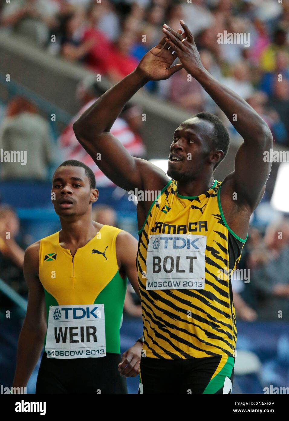 Jamaica's Usain Bolt, right, celebrates winning gold with Jamaica's ...