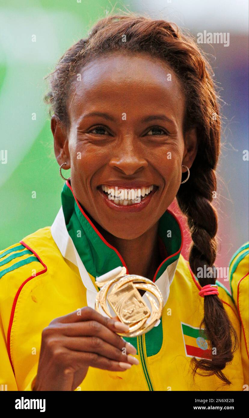 Ethiopia's Meseret Defar poses with her gold medal on the podium for ...