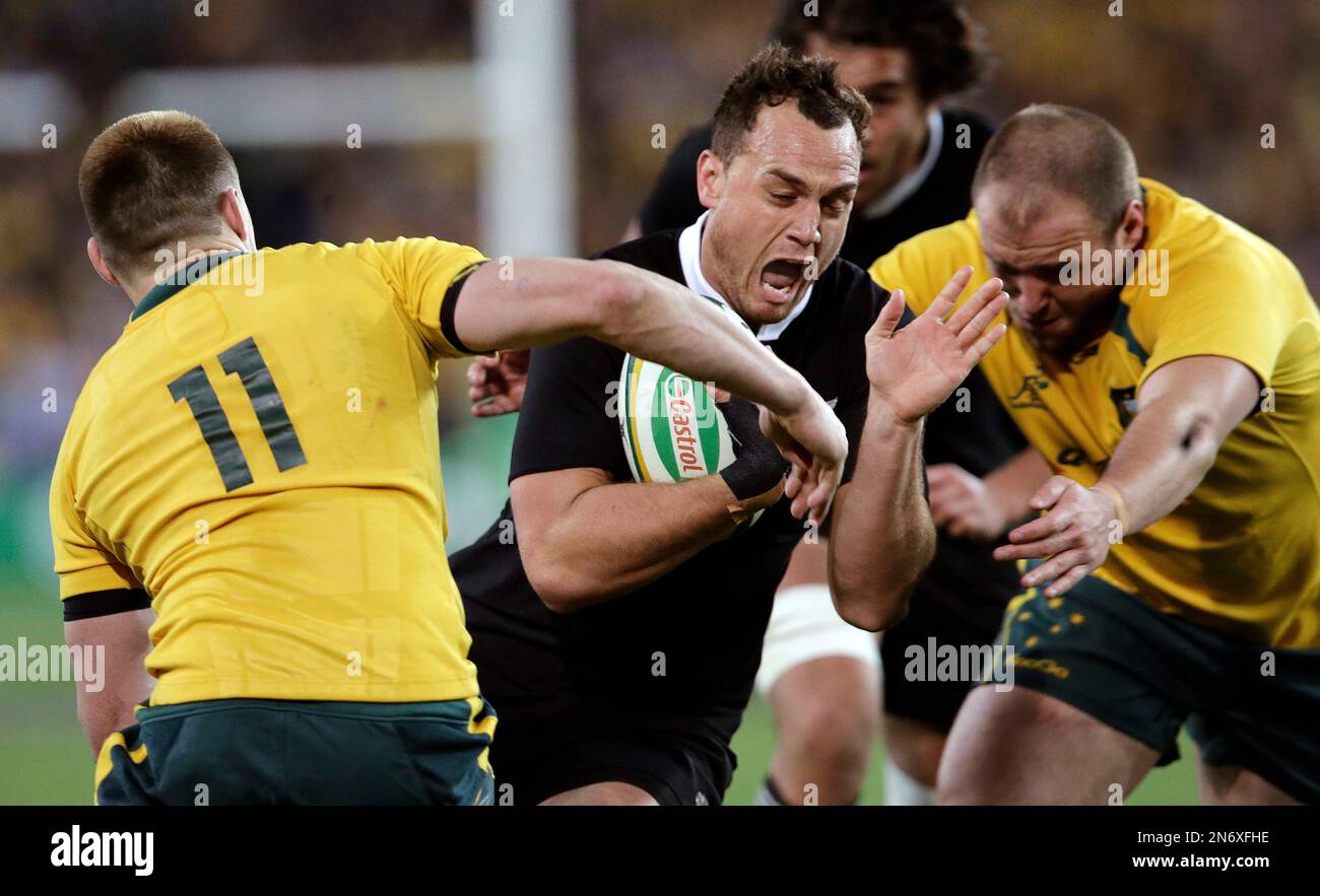 New Zealand's Israel Dagg, center, is tackled by Australia's James O ...