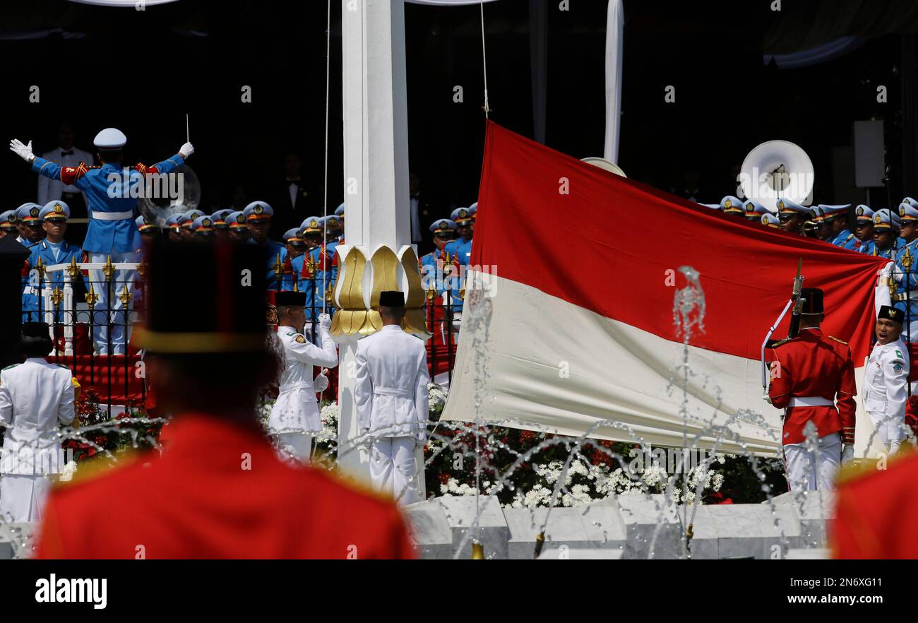 Flag bearers hoist Indonesian national Red-White flag during a ceremony ...