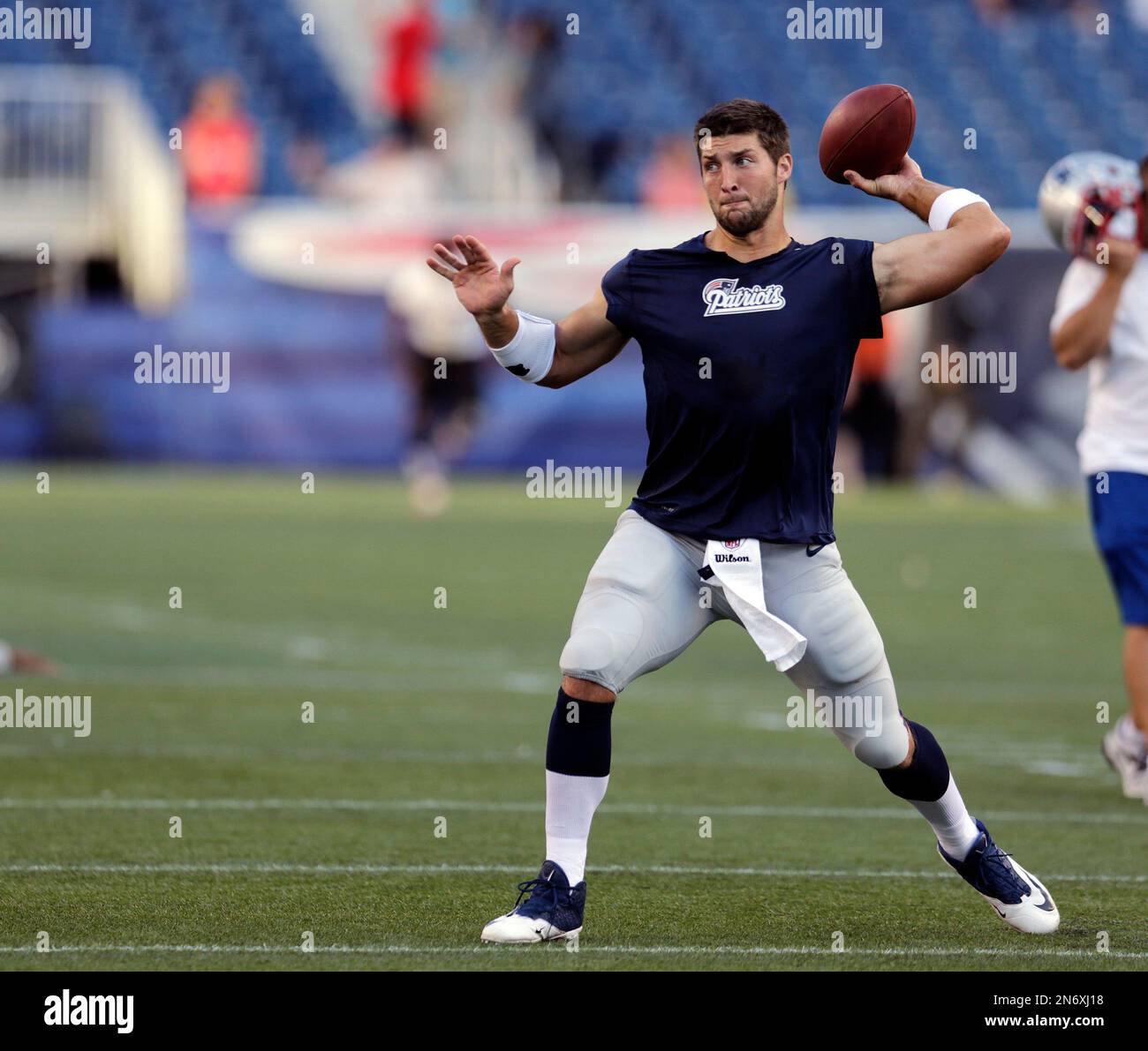New England Patriots quarterback Tim Tebow warms up before an NFL ...