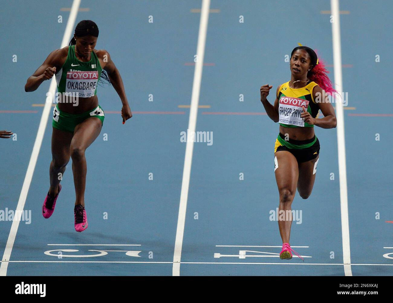 Jamaica's Shelly-Ann Fraser-Pryce, right, crosses the finish line to ...
